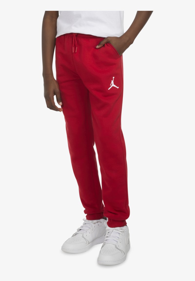 Jordan ESSENTIALS PANT UNISEX - Tracksuit bottoms - gym red/red ...