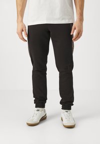 Puma KING TOP PANTS - Trainingsbroek - black/shadow gray/zwart - Zalando.nl