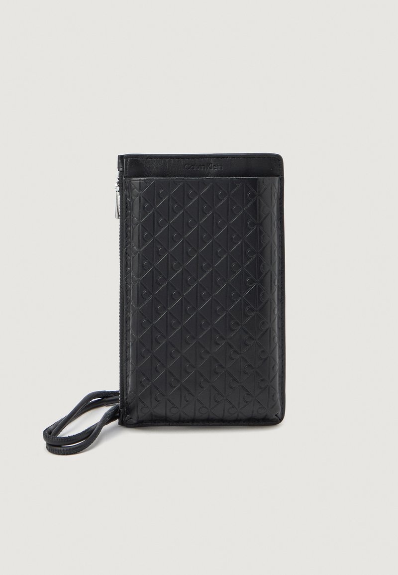 Calvin Klein EMBOSSED EMBLEM PHONE CROSSBODY - Phone pouch - black ...