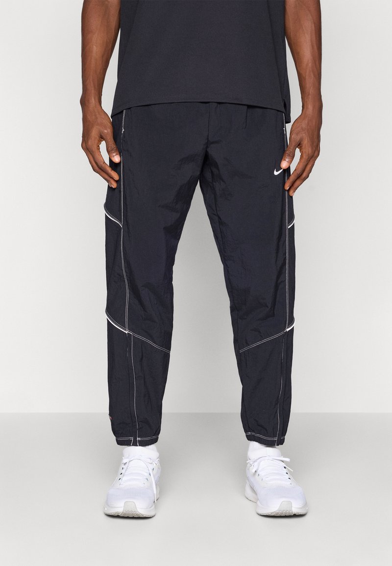 Nike Performance RETRO TRACK PANT - Tracksuit bottoms - black ...