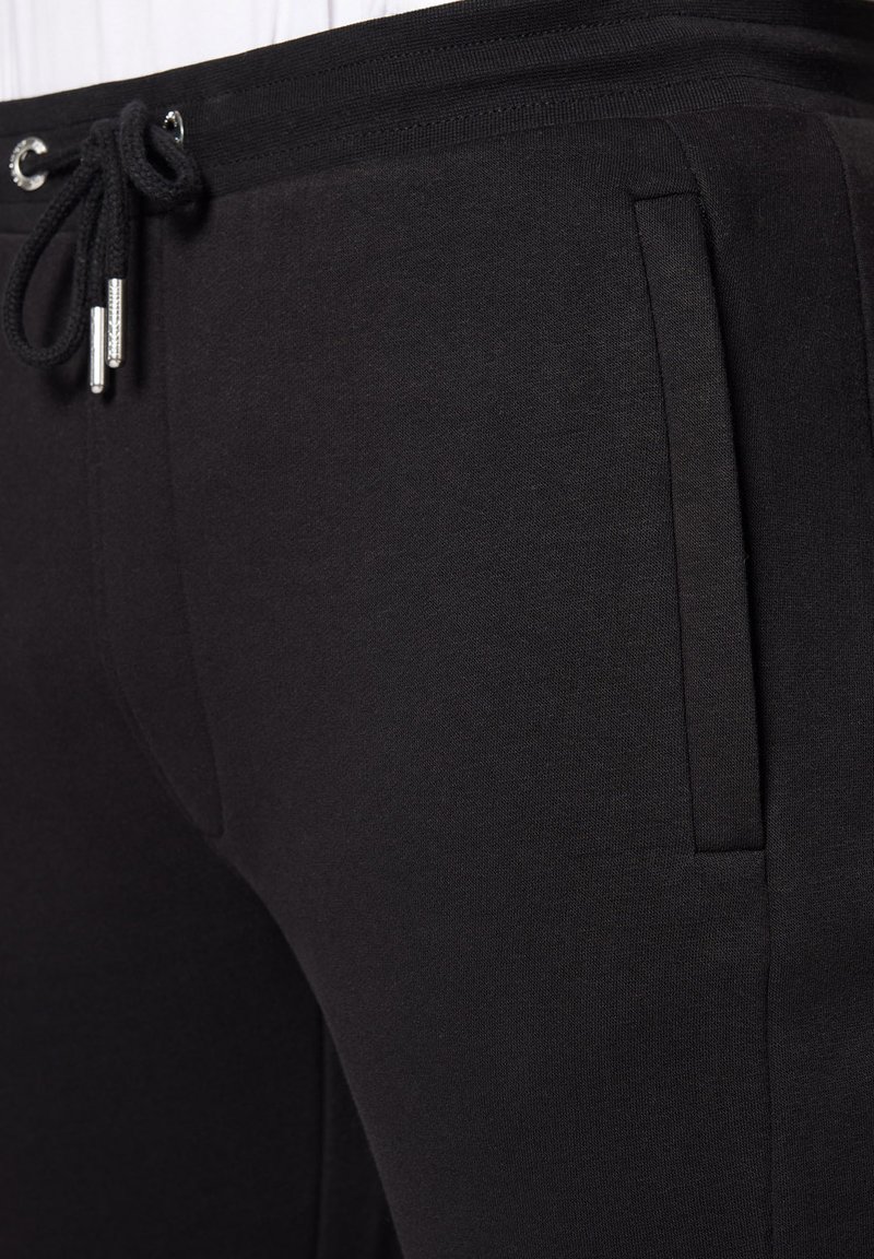 PRÓCHNIK - Spodnie treningowe/czarny - Zalando.pl