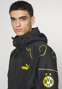 Puma BVB BORUSSIA DORTMUND FTBLSTATEMENT HOODED JACKET - Trainingsvest ...