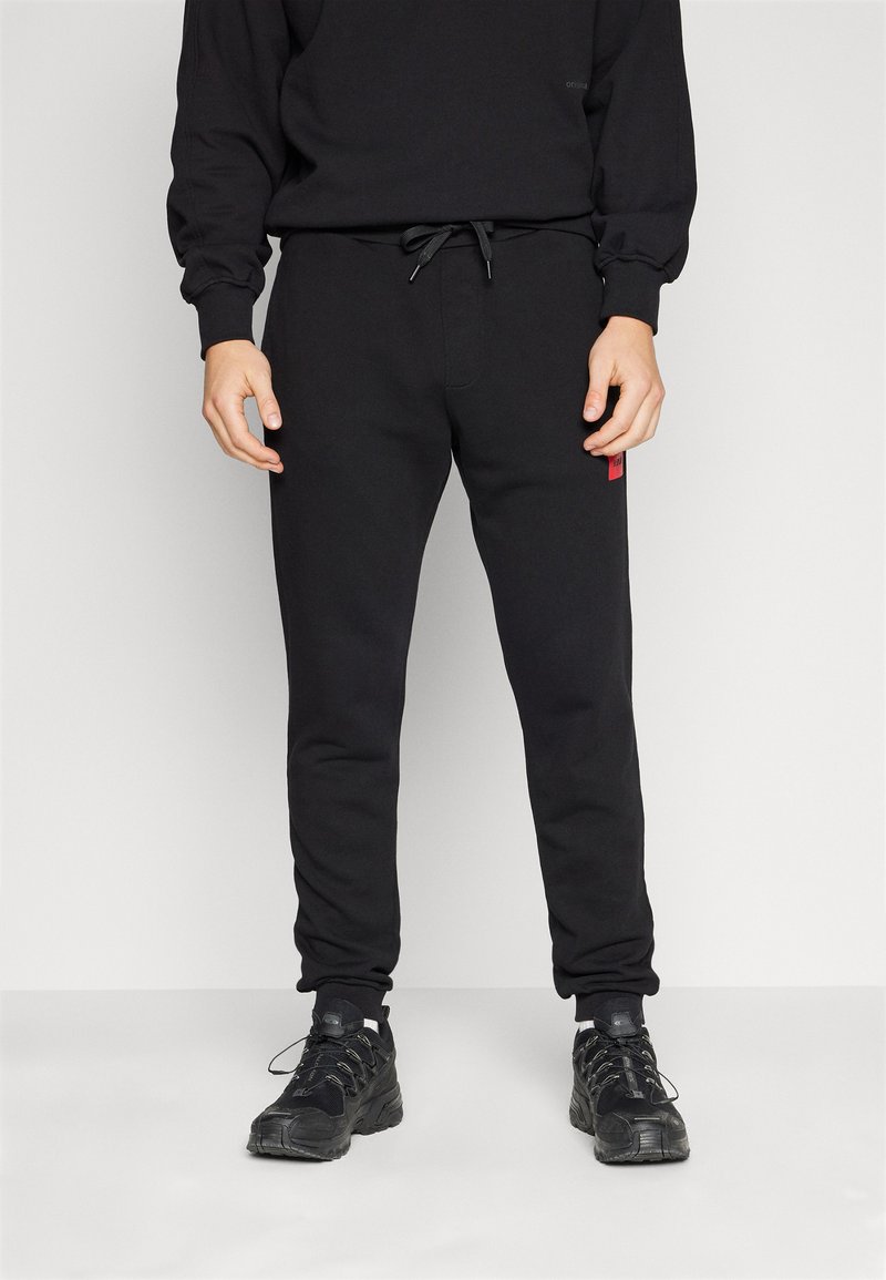 Replay PANTS - Tracksuit bottoms - black - Zalando.ie