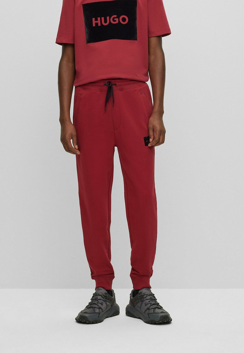 HUGO DOAK - Tracksuit bottoms - dark red four/dark red - Zalando.co.uk