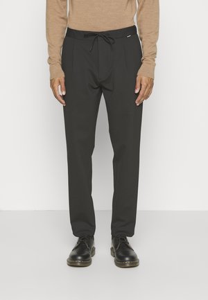 Weekday KEN TRACKPANTS UNISEX - Pantalones - black/negro - Zalando.es