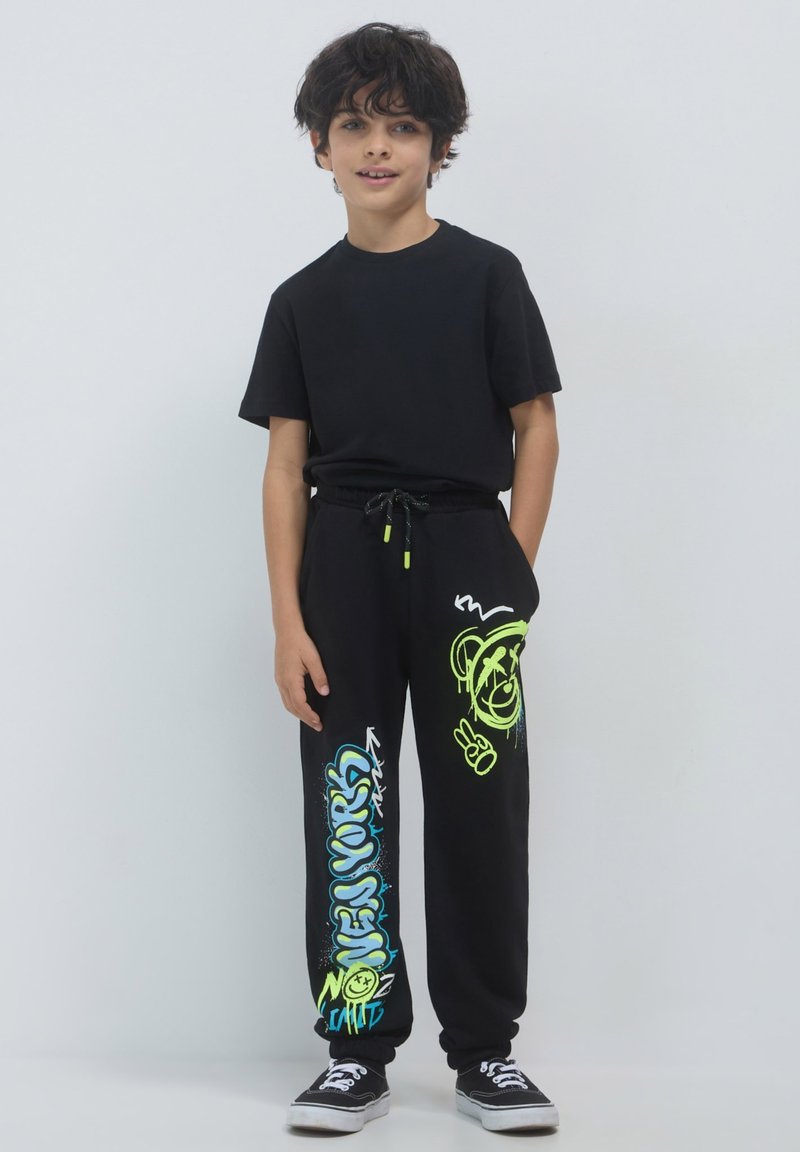 Calliope GINNICO STAMPE GRAFFITI - Tracksuit bottoms - nero ultrablack ...