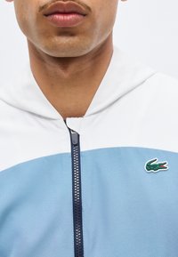 Lacoste Sport Training jacket - navy blue/aral/white/dark blue ...