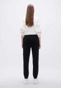 Lacoste Tracksuit bottoms - black - Zalando