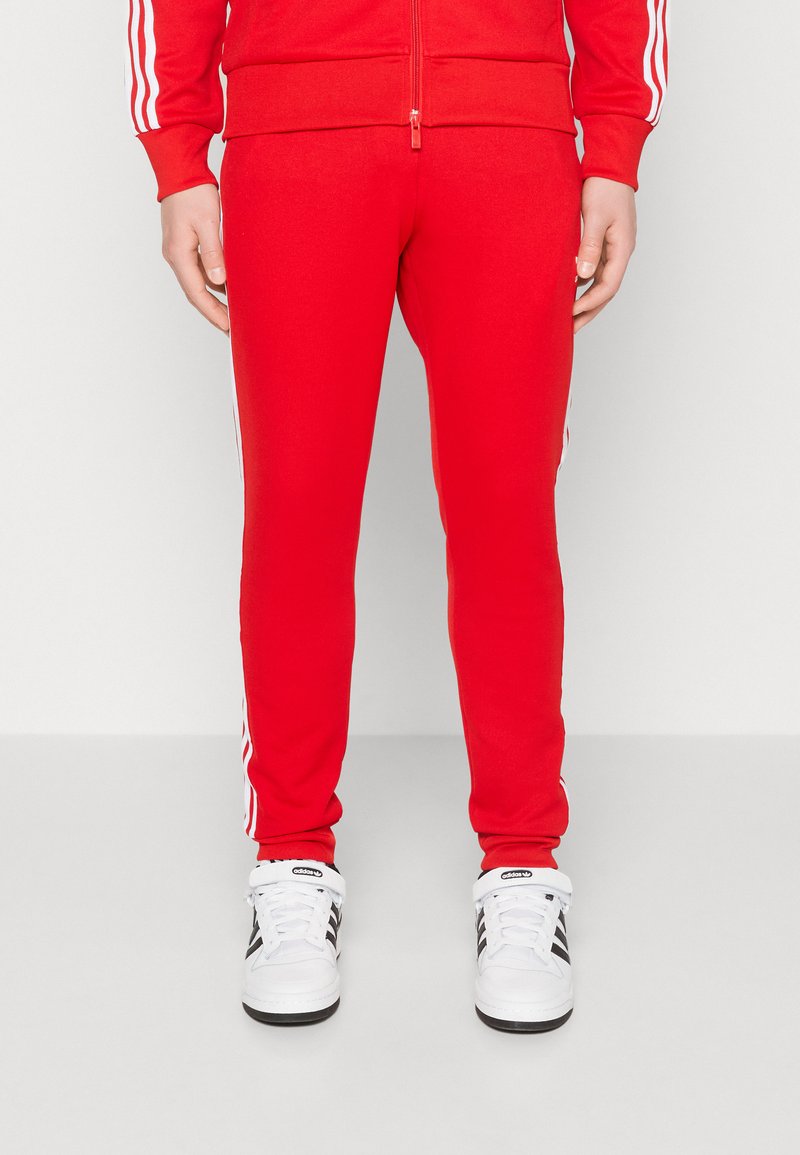 adidas Originals UNISEX - Tracksuit bottoms - better scarlet/white/red ...