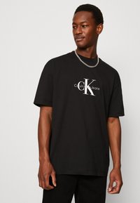 Calvin Klein Jeans MONOLOGO TEE UNISEX - T-Shirt print - black/schwarz - Zalando.at