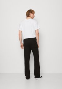 Night Addict Jogginghose - black/schwarz - Zalando.ch