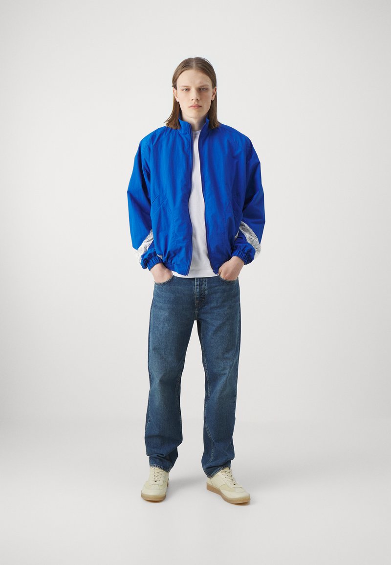 Nikolaj Storm TRACK JACKET UNISEX - Trainingsjacke - logo blue/blau ...