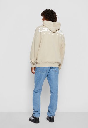 Karl Kani COLLEGE SIGNATURE - Jersey con capucha - off white/blanco ...