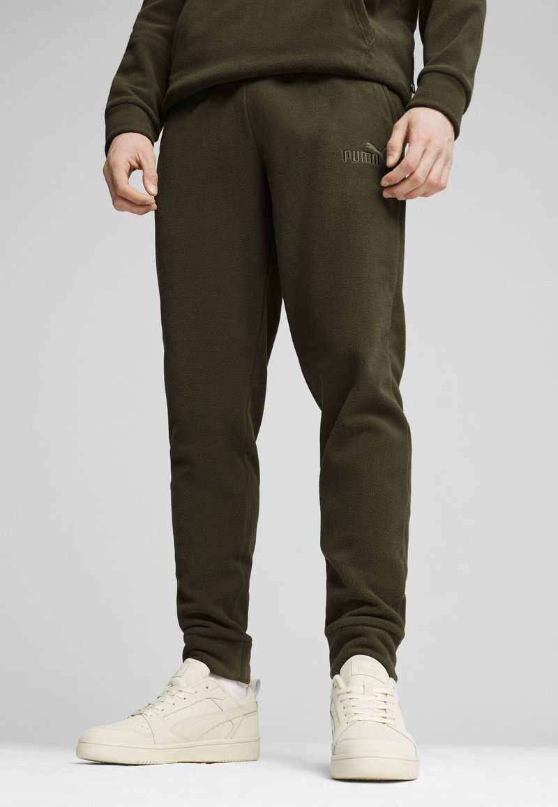 Puma ELEVATED - Tracksuit bottoms - dark olive/green - Zalando