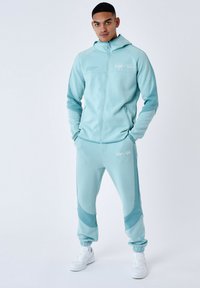 Project X Paris JOGGING TWO TONE - Tracksuit bottoms - cyan/neon blue ...