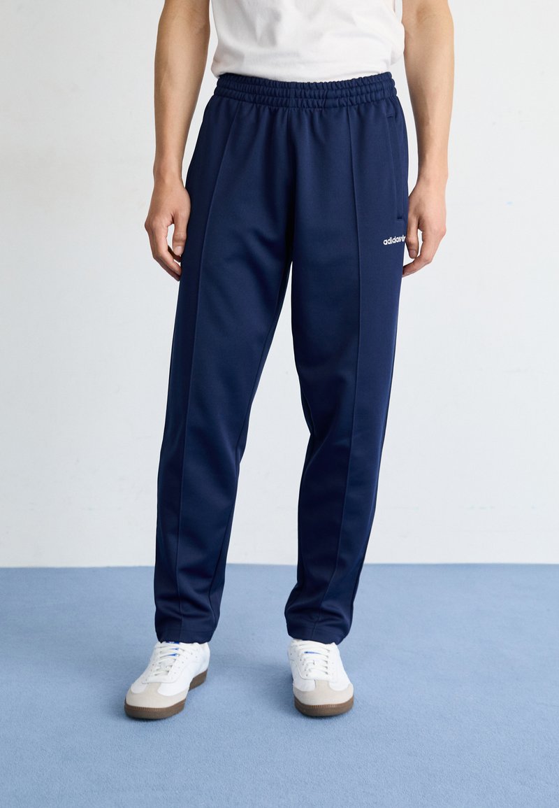 adidas Originals FIRST - Tracksuit bottoms - night indigo/dark blue ...