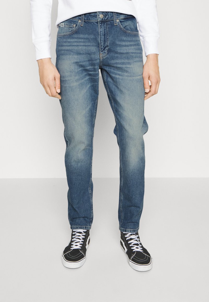 Calvin Klein Jeans SLIM - Jeans Tapered Fit - denim medium/blue denim ...