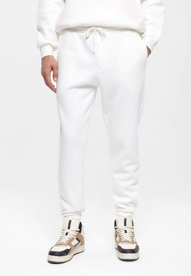 Antioch Tracksuit bottoms - ecru/off-white - Zalando