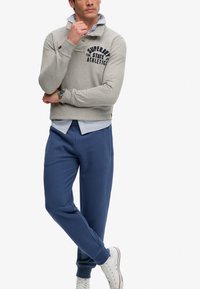 Superdry & Co ESSENTIAL LOGO JOGGERS - Tracksuit bottoms - vintage ...