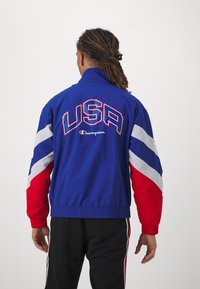 Champion RETRO SPORT CRINCLE JACKET - Sportovní bunda - blue/modrá ...