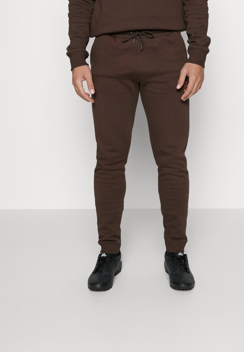 KLABU LOGO PANTS - Tracksuit bottoms - chocolate brown/vibrant orange ...