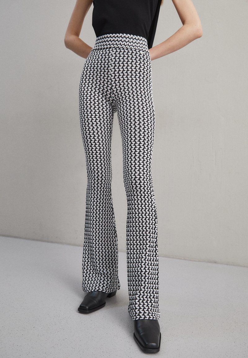 KOCHÉ PANTS - Trousers - black/white/black - Zalando.ie