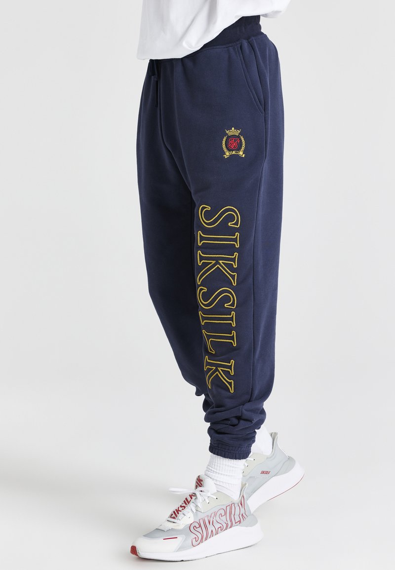 Siksilk Crest Embroidery Relaxed Fit Tracksuit Bottoms Navy Dark