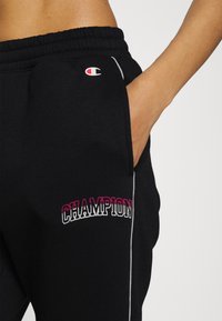 Champion COLOR PUNCH RIB CUFF PANTS - Pantalones deportivos - nbk/negro ...