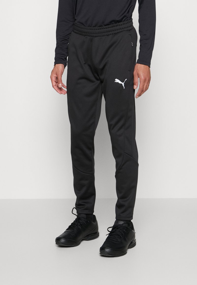 Puma EVOSTRIPE WARM PANTS - Tracksuit bottoms - black - Zalando.co.uk
